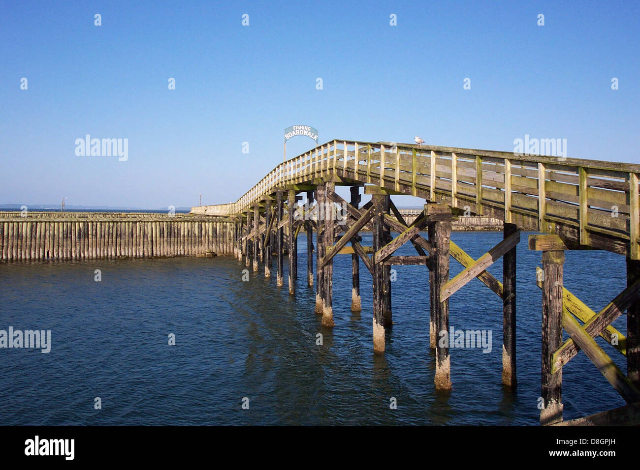 A bridge extending across the sea, connecting land masses over water ...