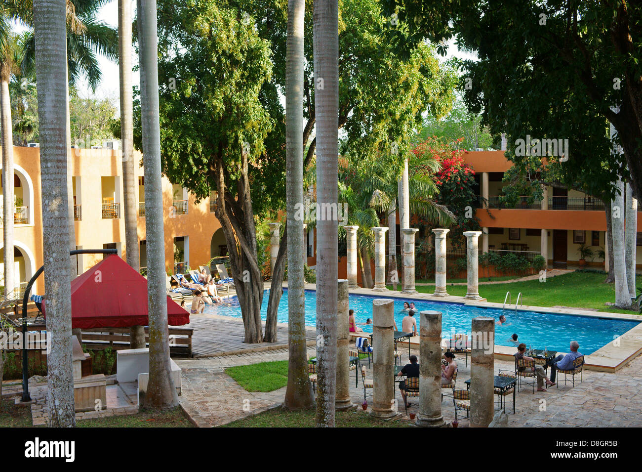 Guests using the swimming pool at the Hotel Hacienda Uxmal near the ...