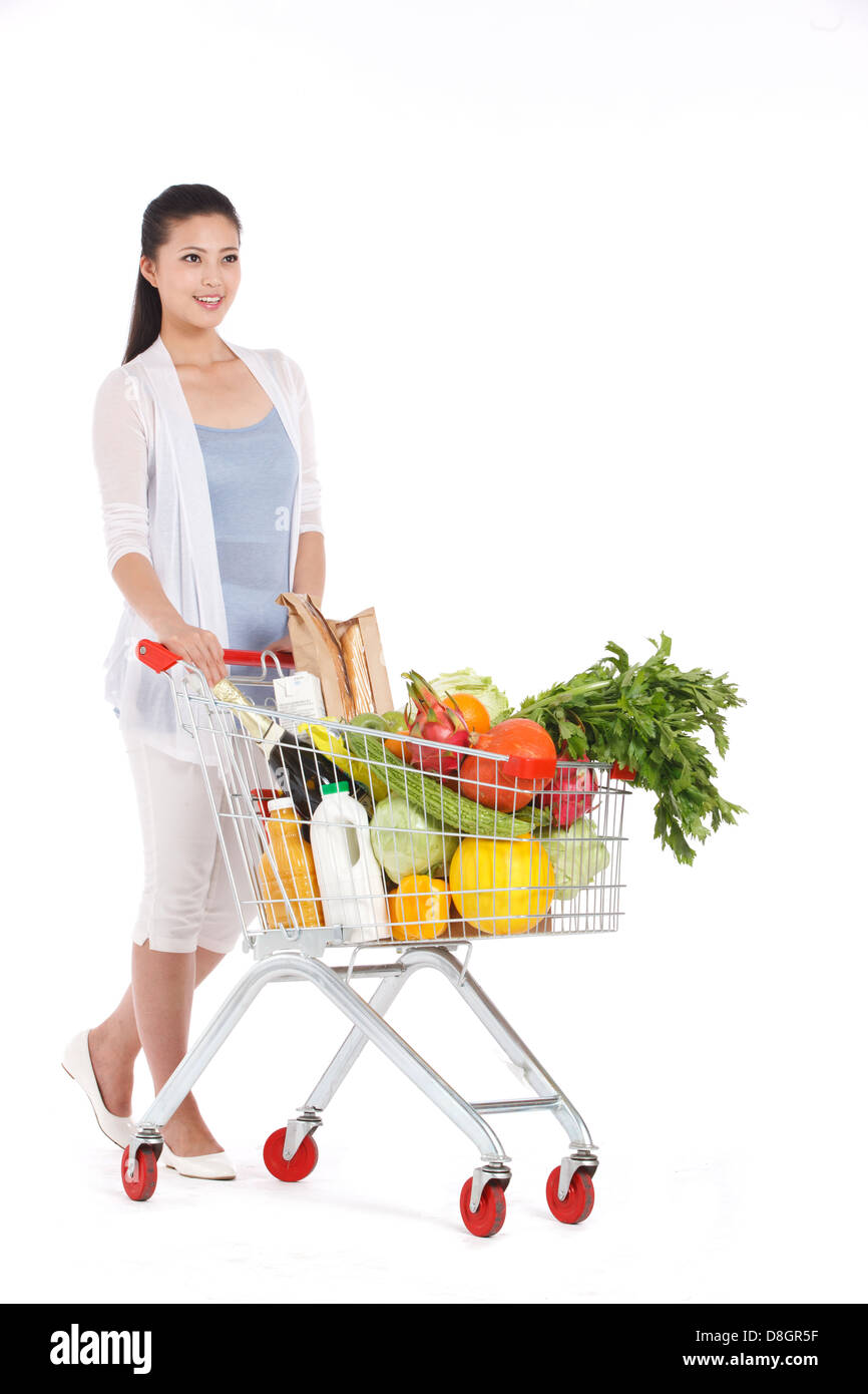 Young woman shopping with shopping cart Stock Photo - Alamy