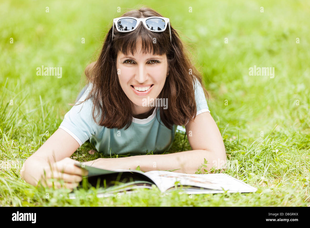 Beauty smiling woman reading book outdoor Stock Photo - Alamy