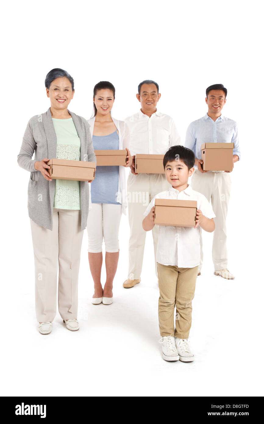 Whole family holding boxes Stock Photo - Alamy