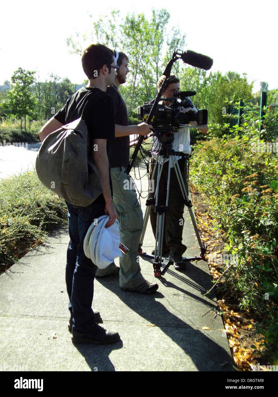 A cameraman and director work together on a film set, focusing on ...