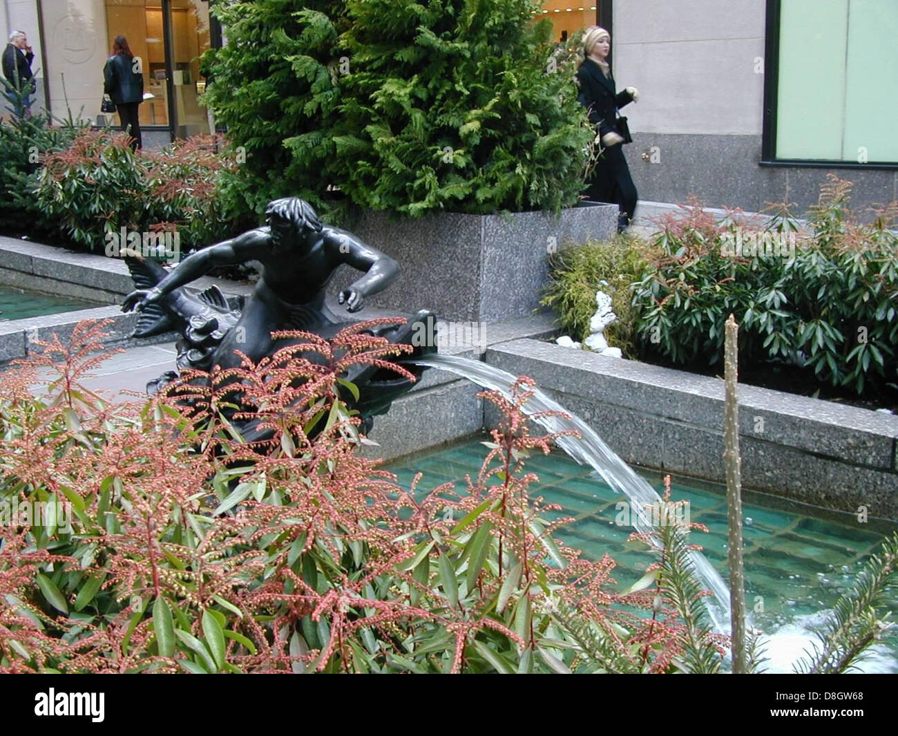 A cast iron fountain featuring intricate designs, with water flowing ...