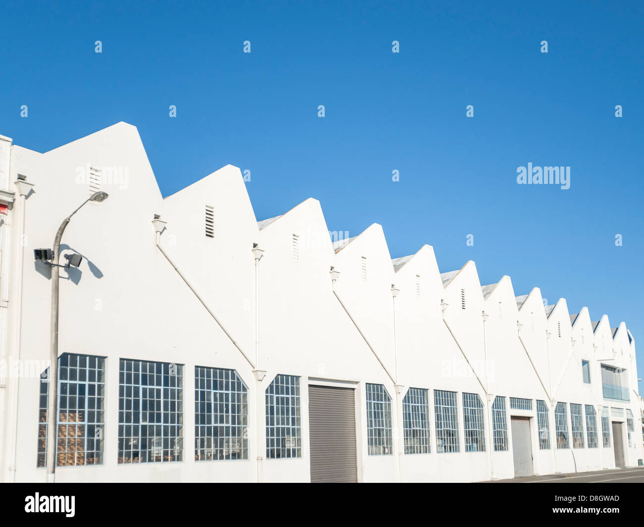 Sawtooth pattern, roof of older industrial building provides a white ...