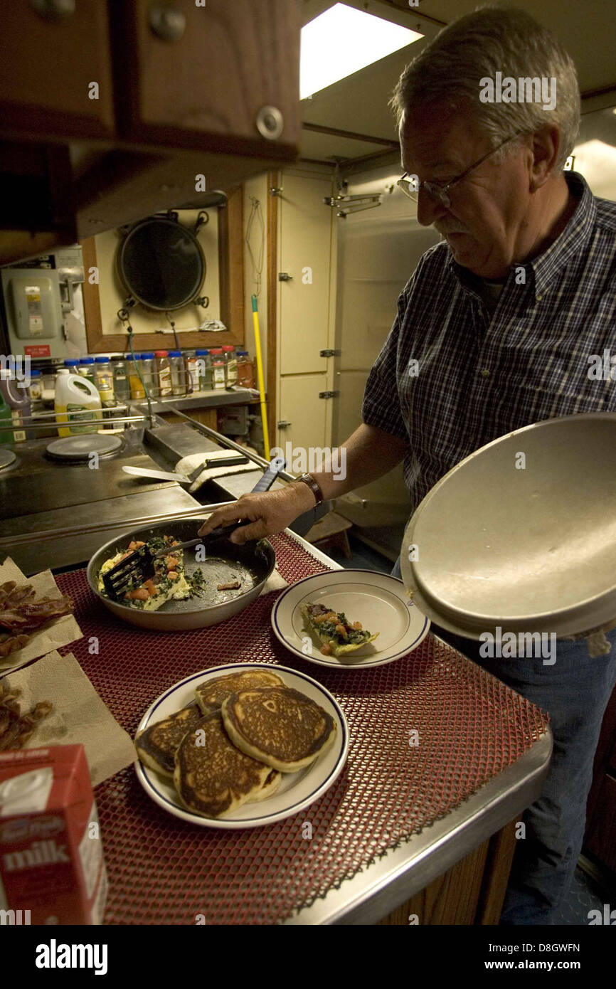 A chef prepares a meal in a professional kitchen, skillfully chopping ...
