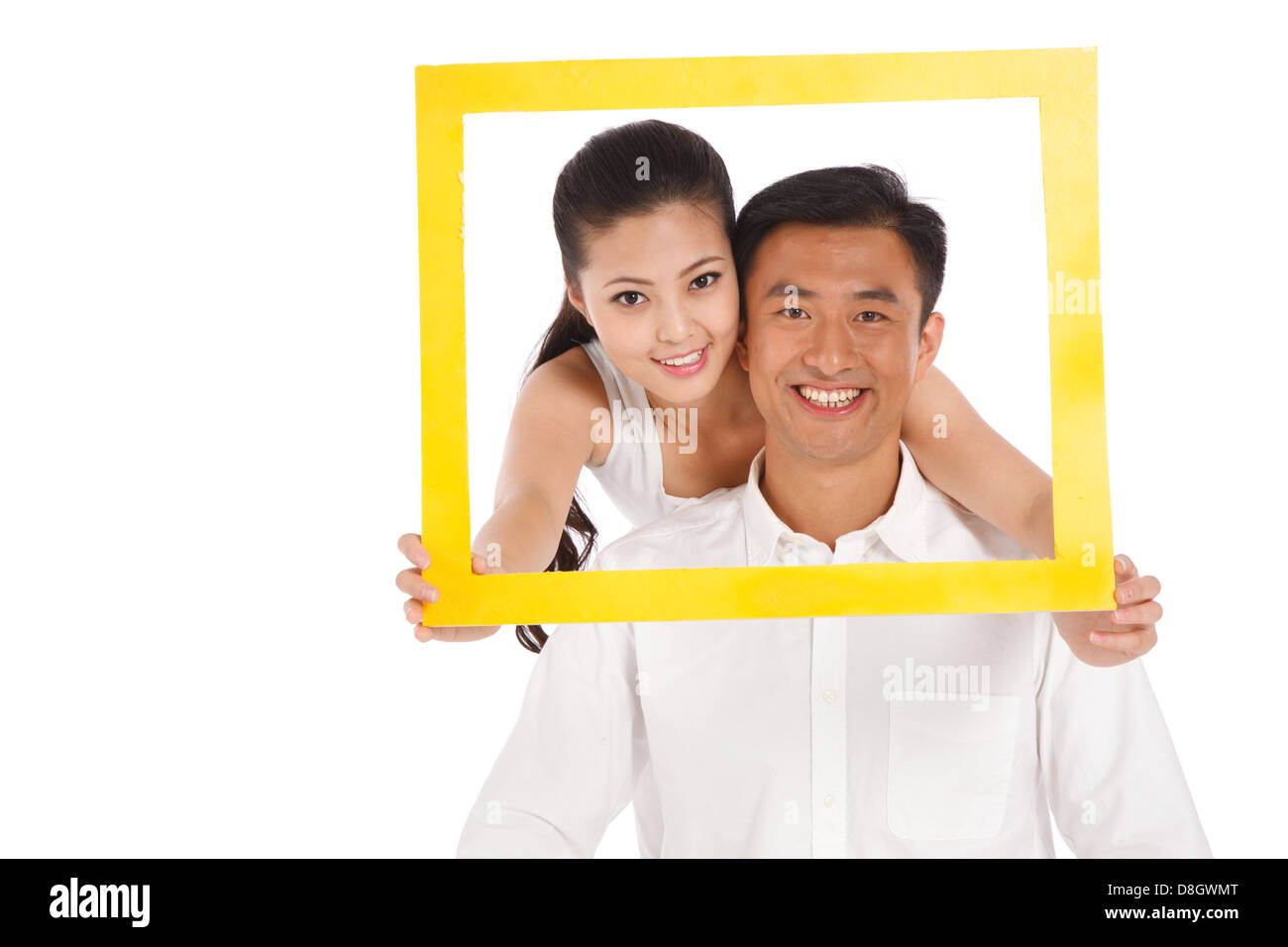 Young couple holding photo frame Stock Photo - Alamy