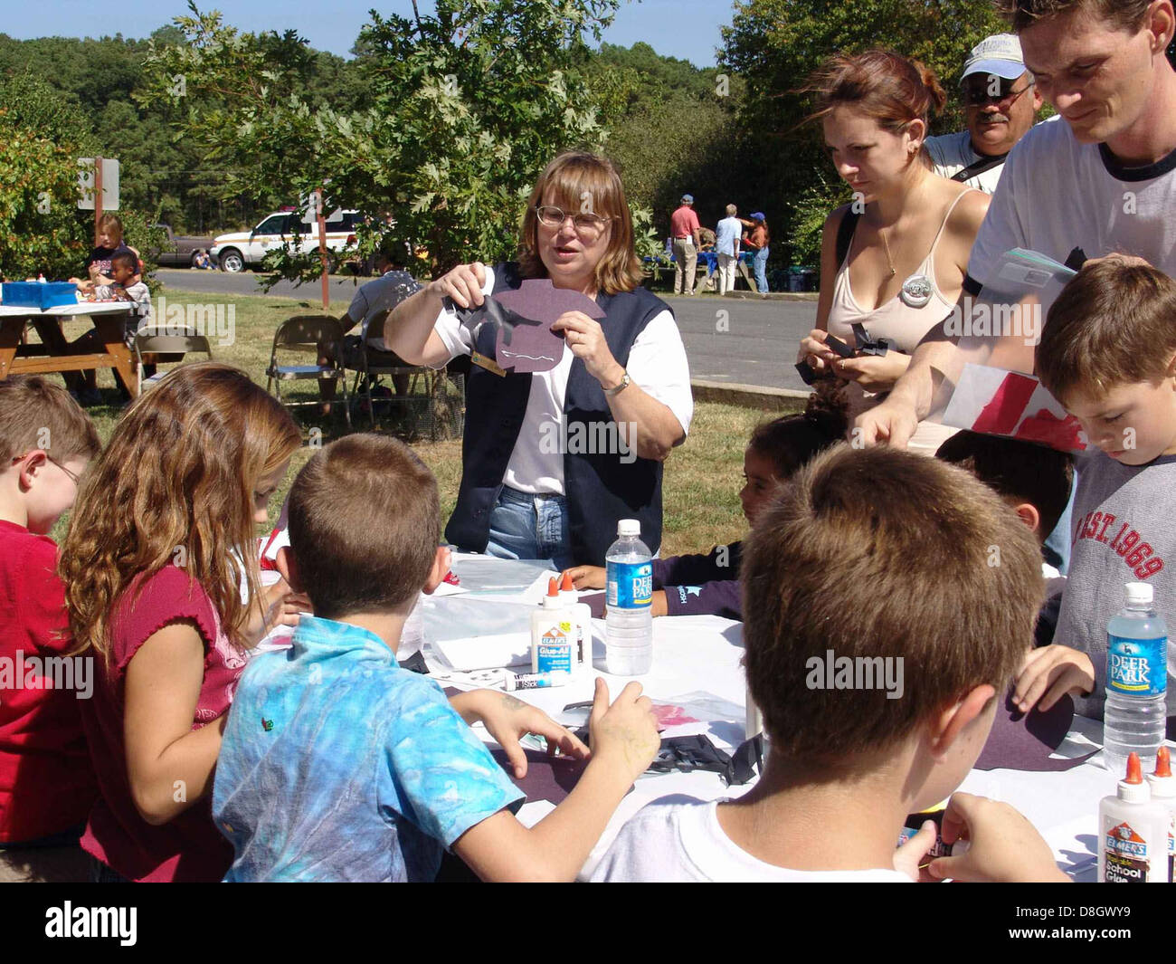 A group of children participates in a craft activity, learning about ...