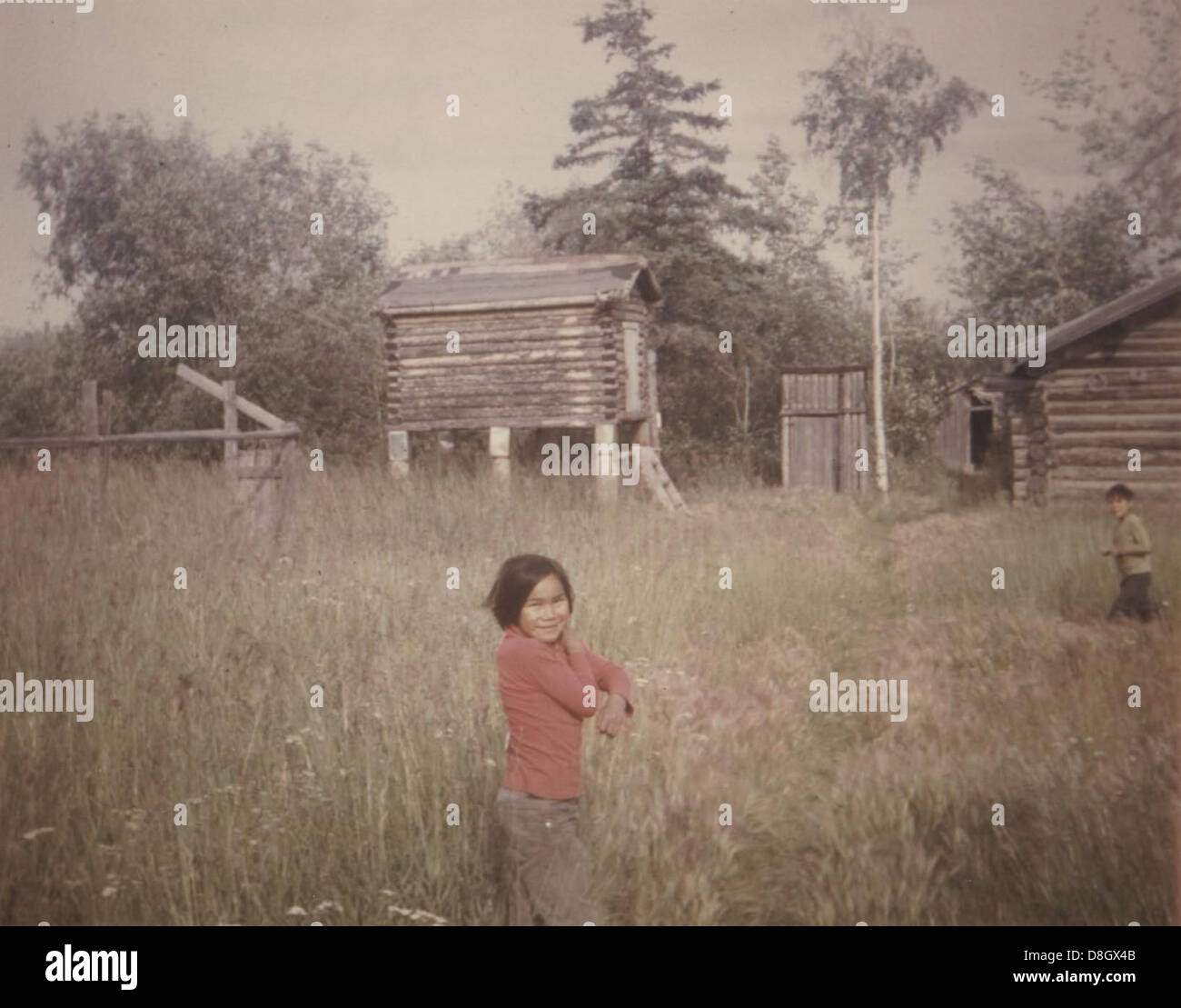 This image depicts children playing together in a village setting ...