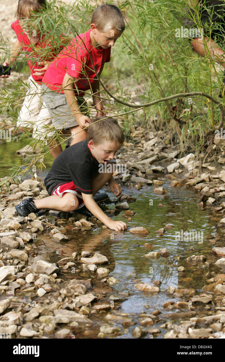Children are seen playing outdoors in a safe, open environment ...