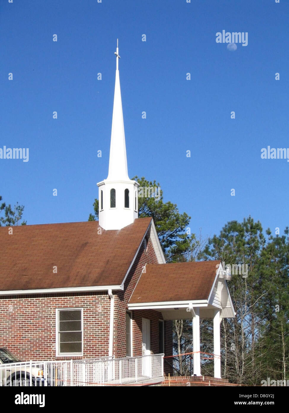 A church steeple bell stands tall, perched at the top of a traditional ...