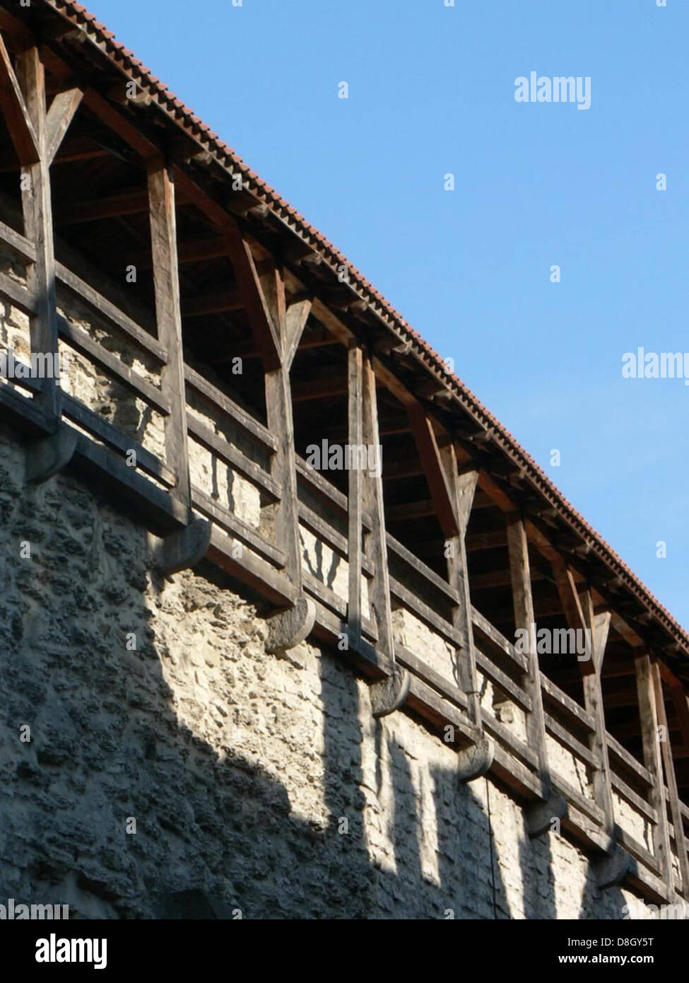 A city wall, often a historical or architectural feature, used to ...