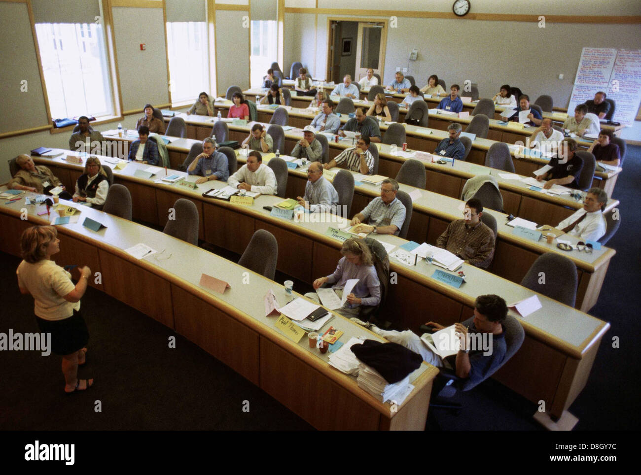 A teacher interacts with students in a classroom, fostering an ...