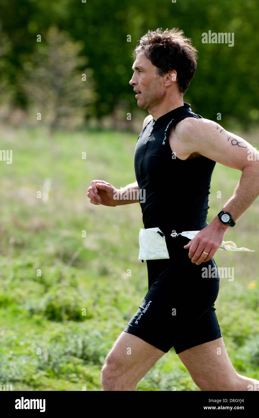 2013 Stratford 220 Triathlon, man running, side view Stock Photo - Alamy