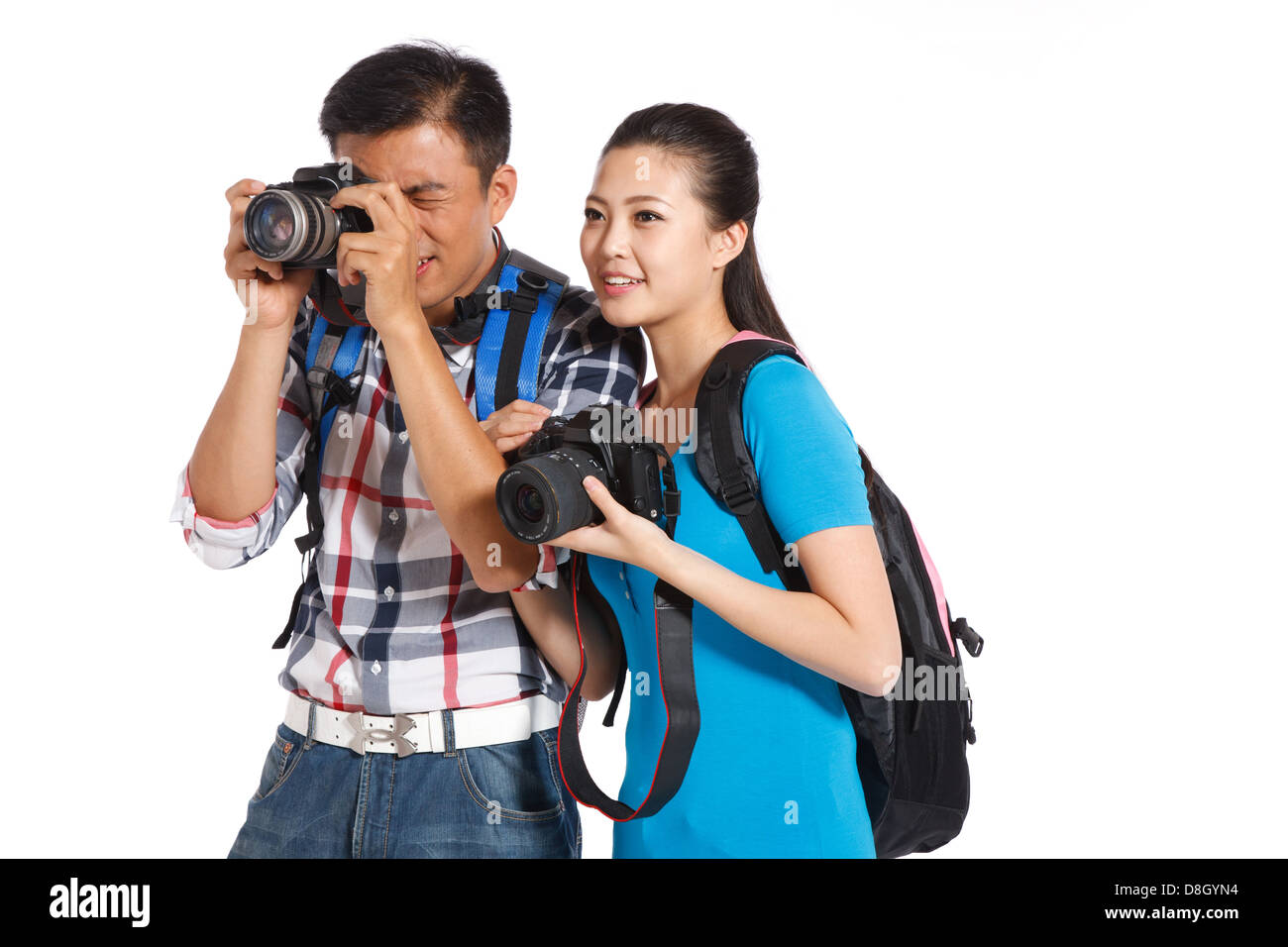 Young couple travelling and carrying camera Stock Photo - Alamy