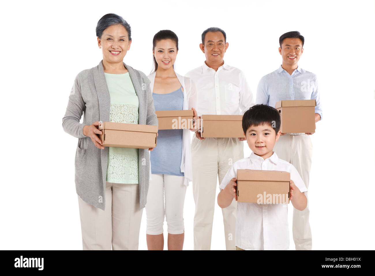 Whole family holding boxes Stock Photo - Alamy