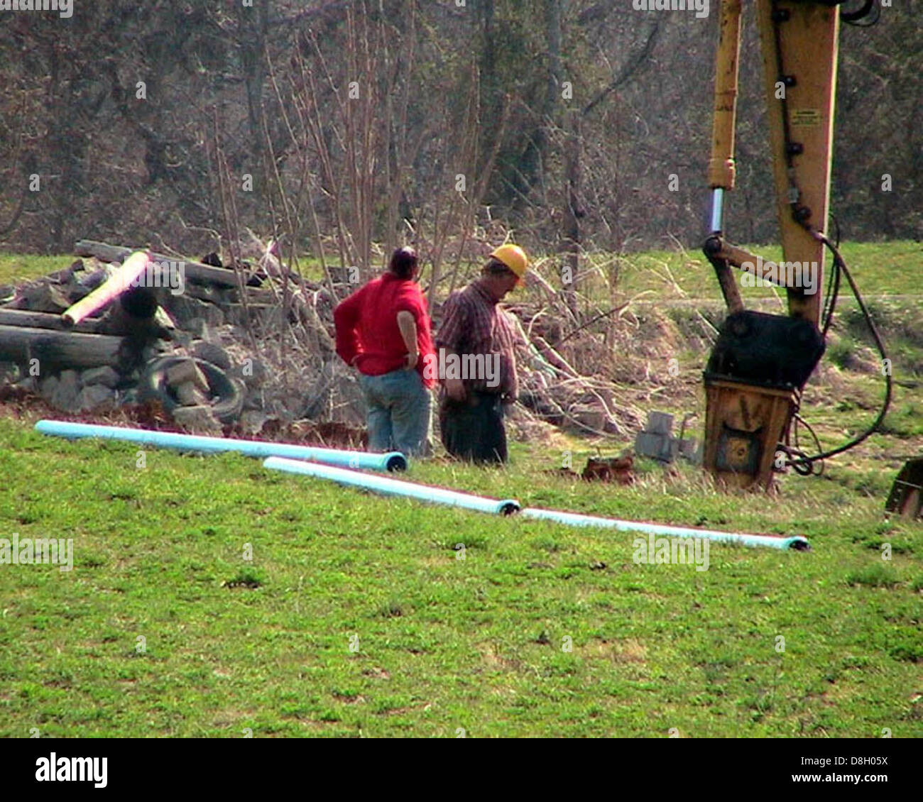 Construction workers are seen working in the field, building a ...