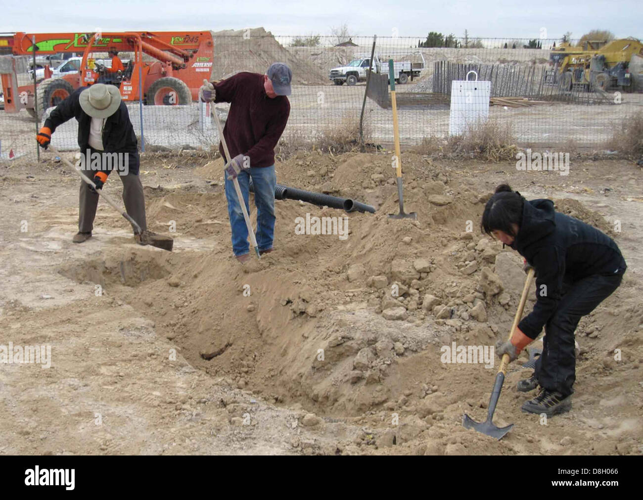 Construction workers are shown on a job site, using tools to complete ...