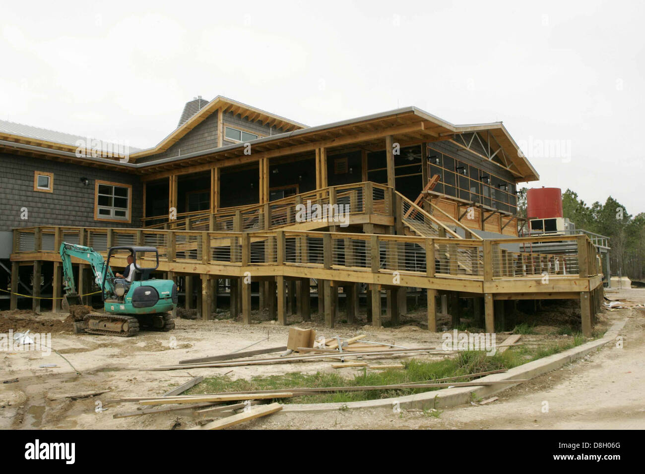 A photo showing the construction of a home, with workers actively ...