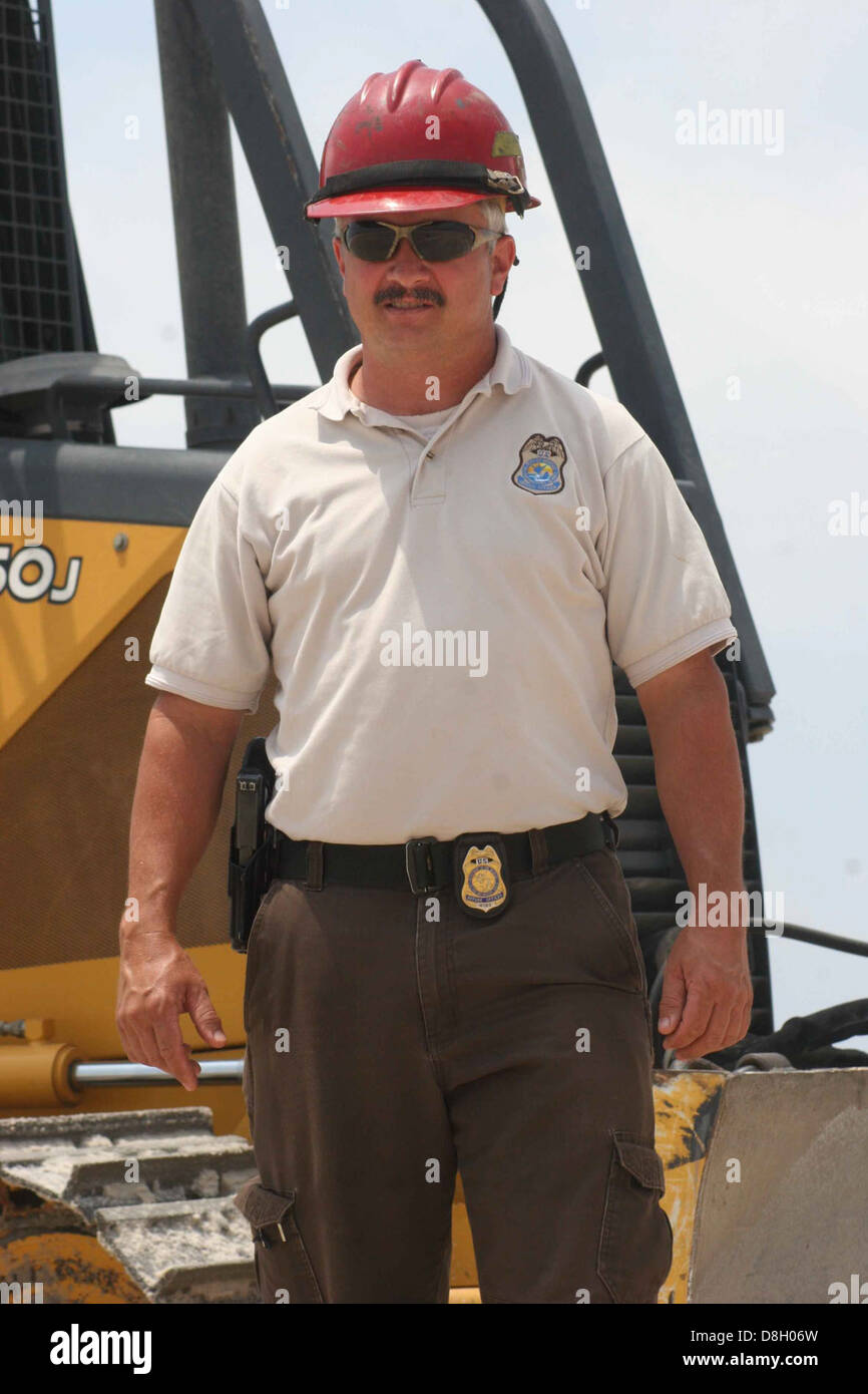 A construction worker operating a bulldozer on a job site. The heavy ...