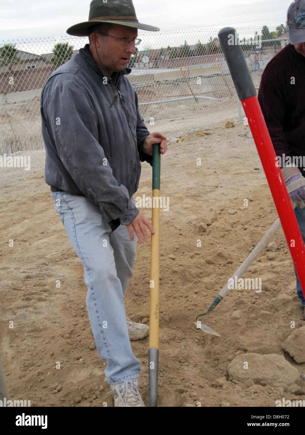 A male construction worker is shown on-site, engaged in construction ...