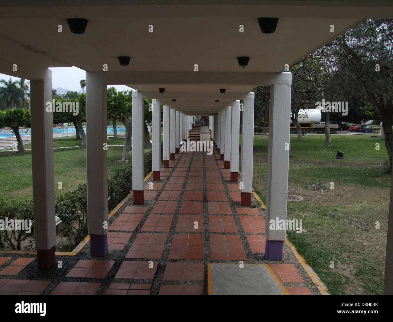 A covered pathway in the Centro Vacacional de Oaxtepec, providing a ...