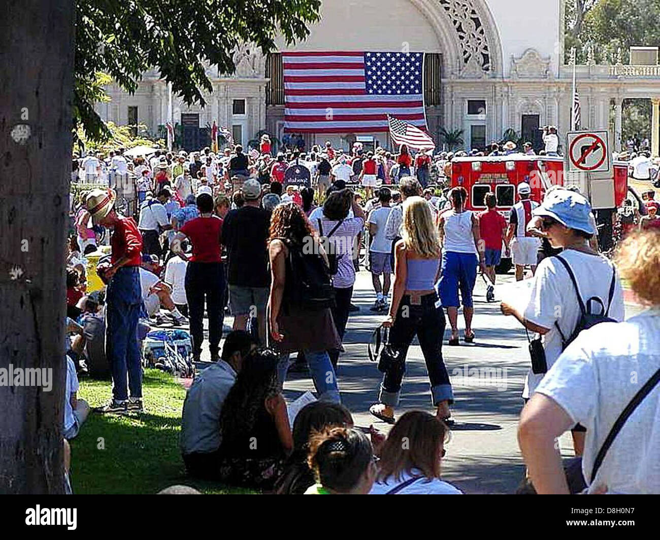 A bustling street scene filled with a crowd of people. The image ...