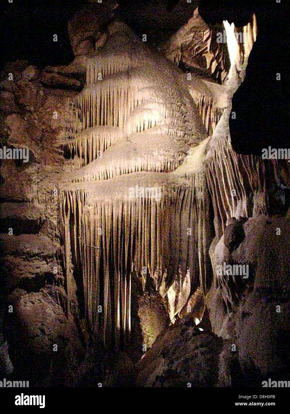 A crystal cave filled with stunning mineral formations. The cave walls ...