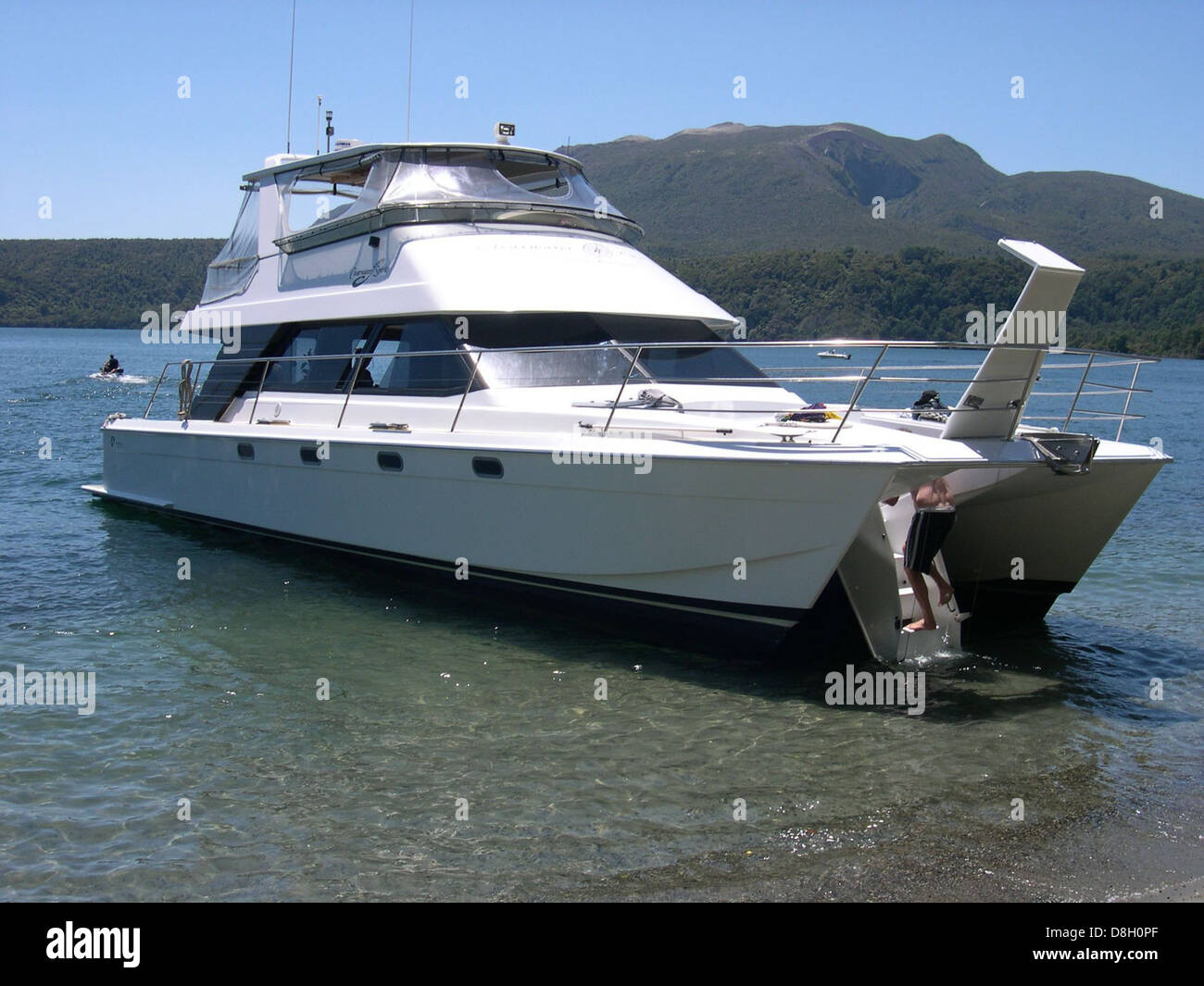 A cruiser yacht, designed for leisure and comfort, is anchored on calm ...