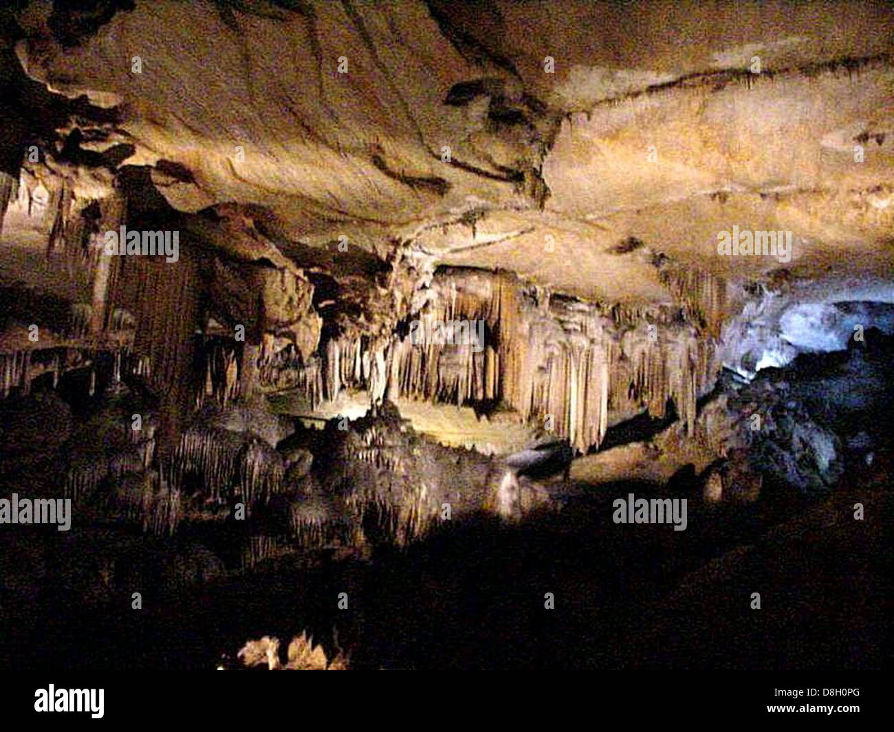 A dramatic image of crystal formations inside a dark cave, with natural ...