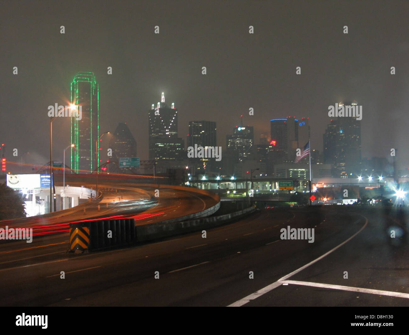 A foggy night scene in Dallas, Texas, where the city’s skyline is ...