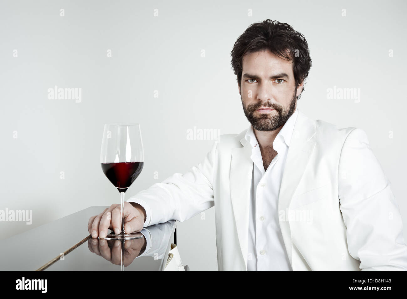 handsome man and a glass of red wine Stock Photo - Alamy