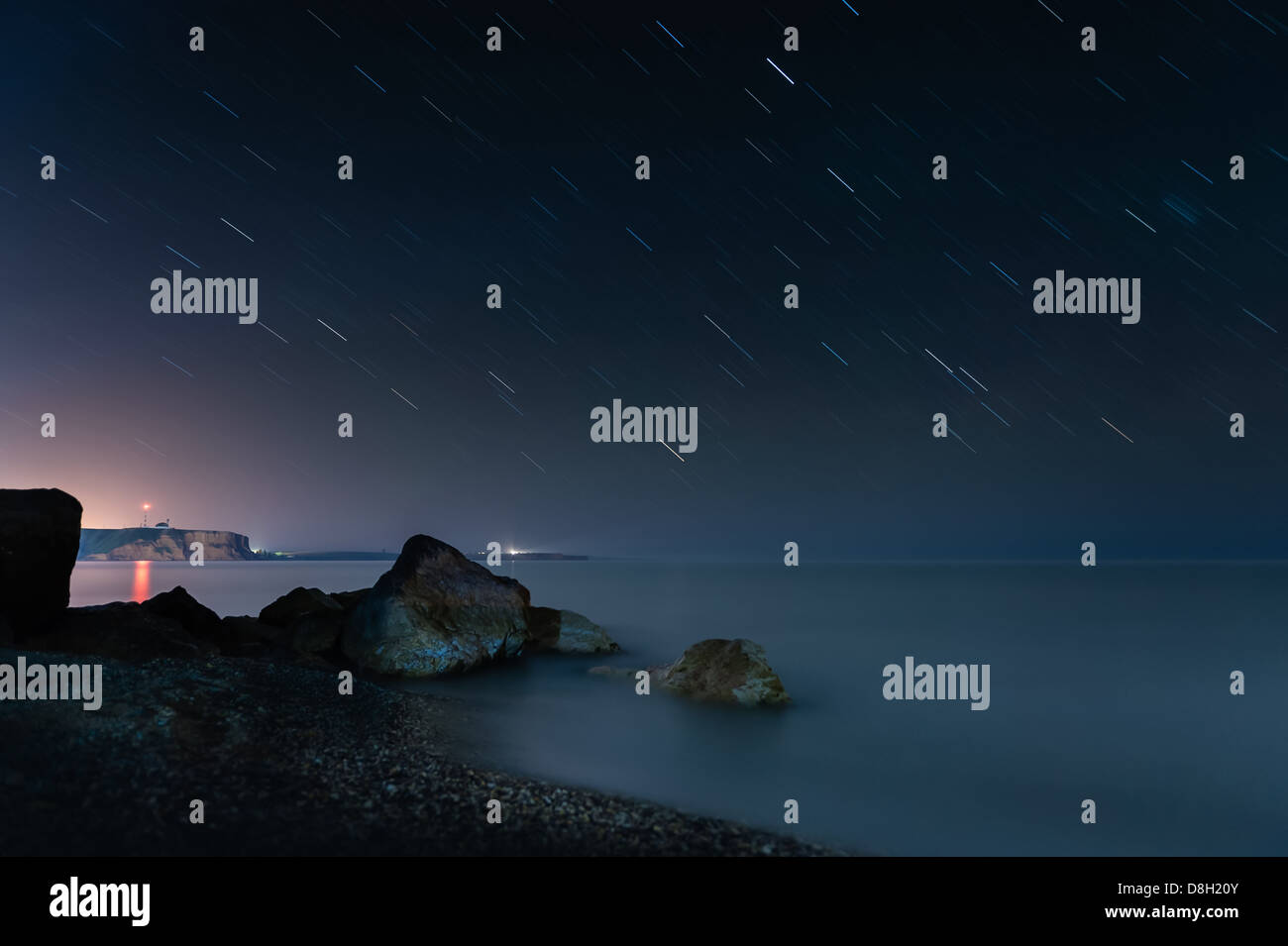 Night beach under star trails Stock Photo - Alamy
