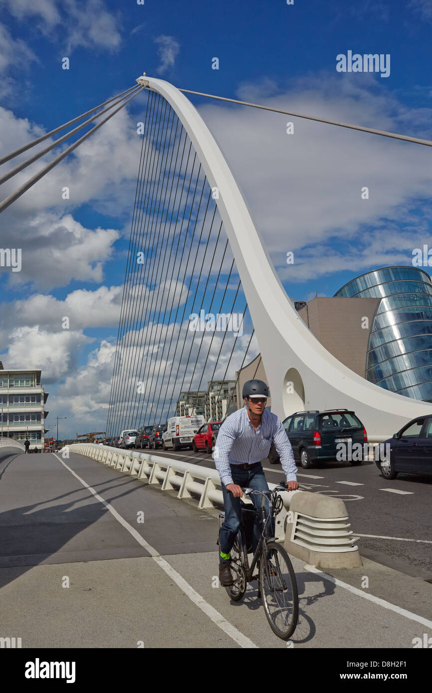 A cyclist crosses the Samuel Beckett Bridge which spans the river ...