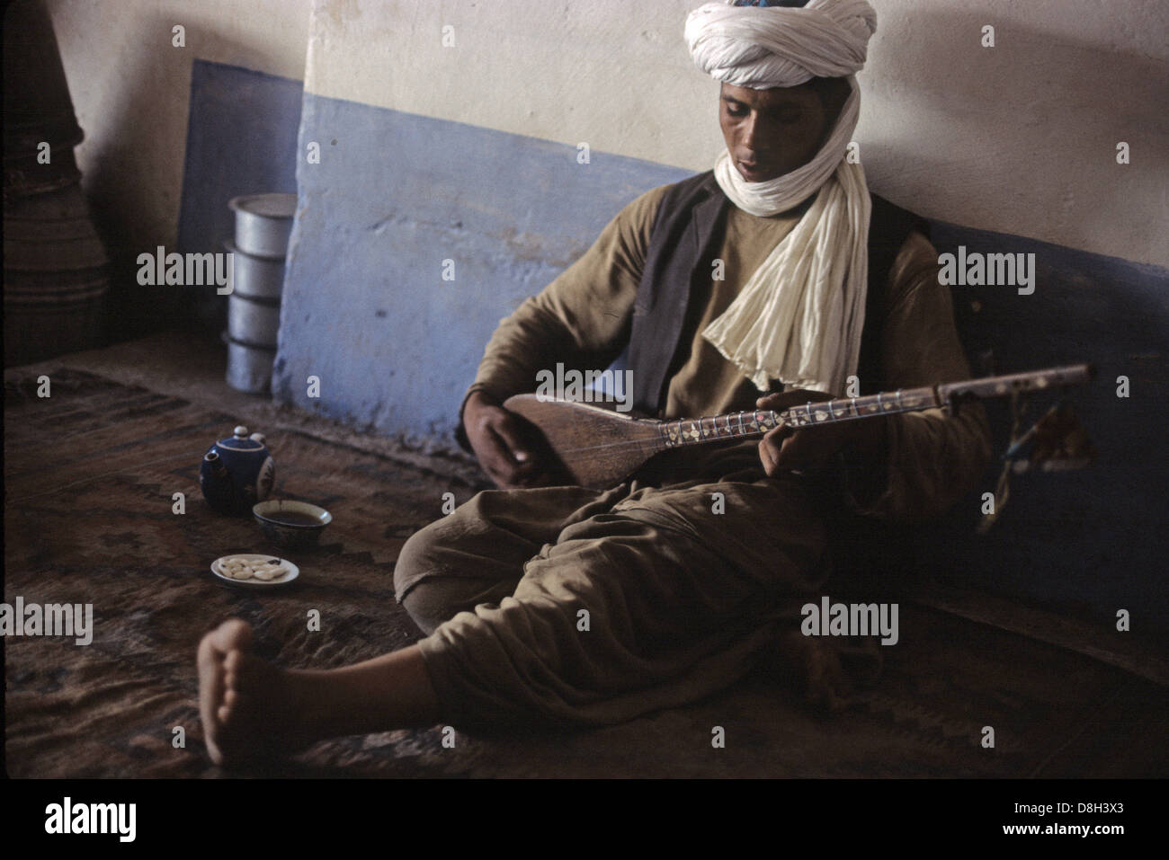 young Afghanistan man playing string instrument Stock Photo - Alamy