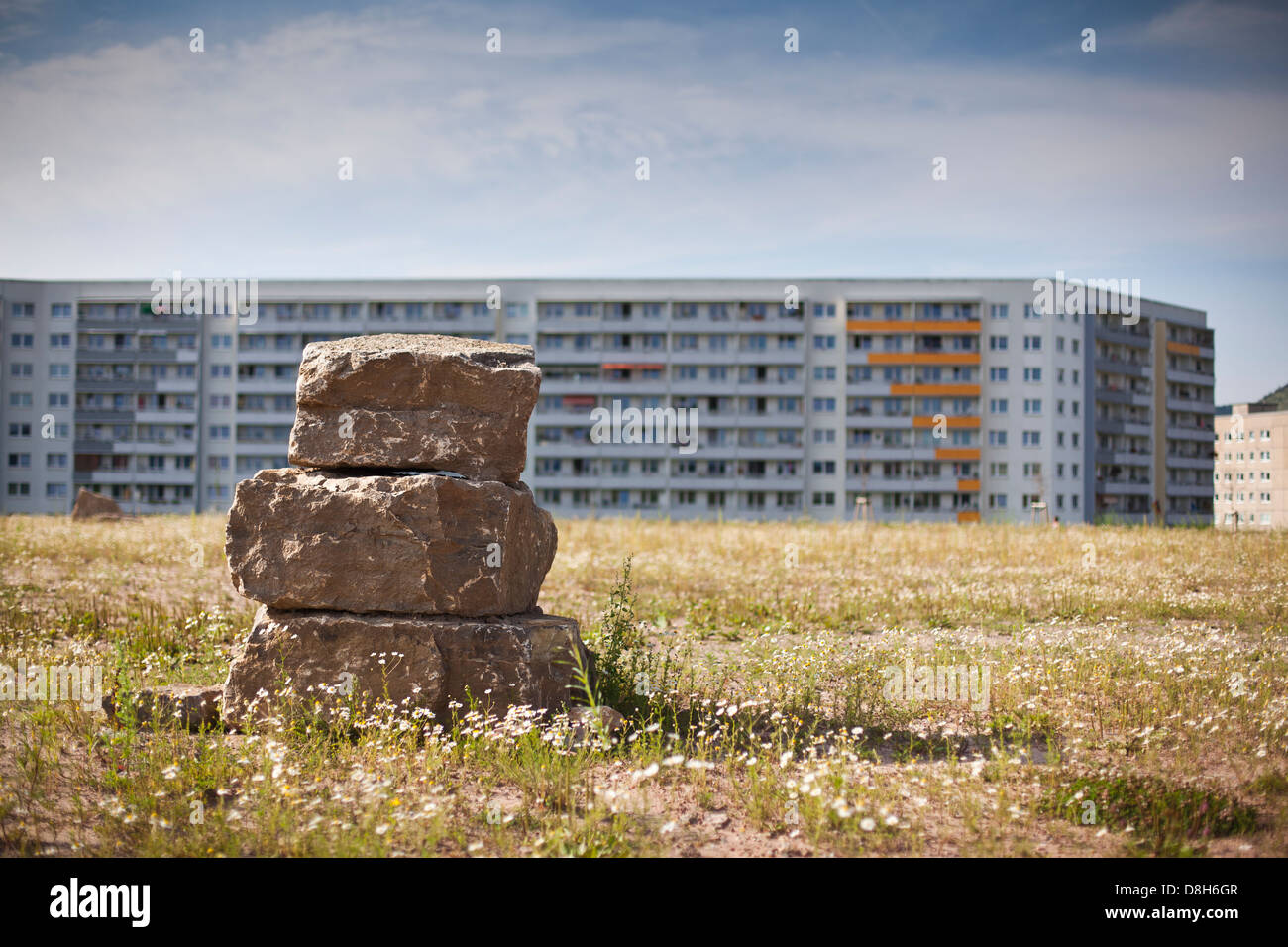 Stacked stones in front of prefabricated buildings, Jena, Thuringia ...