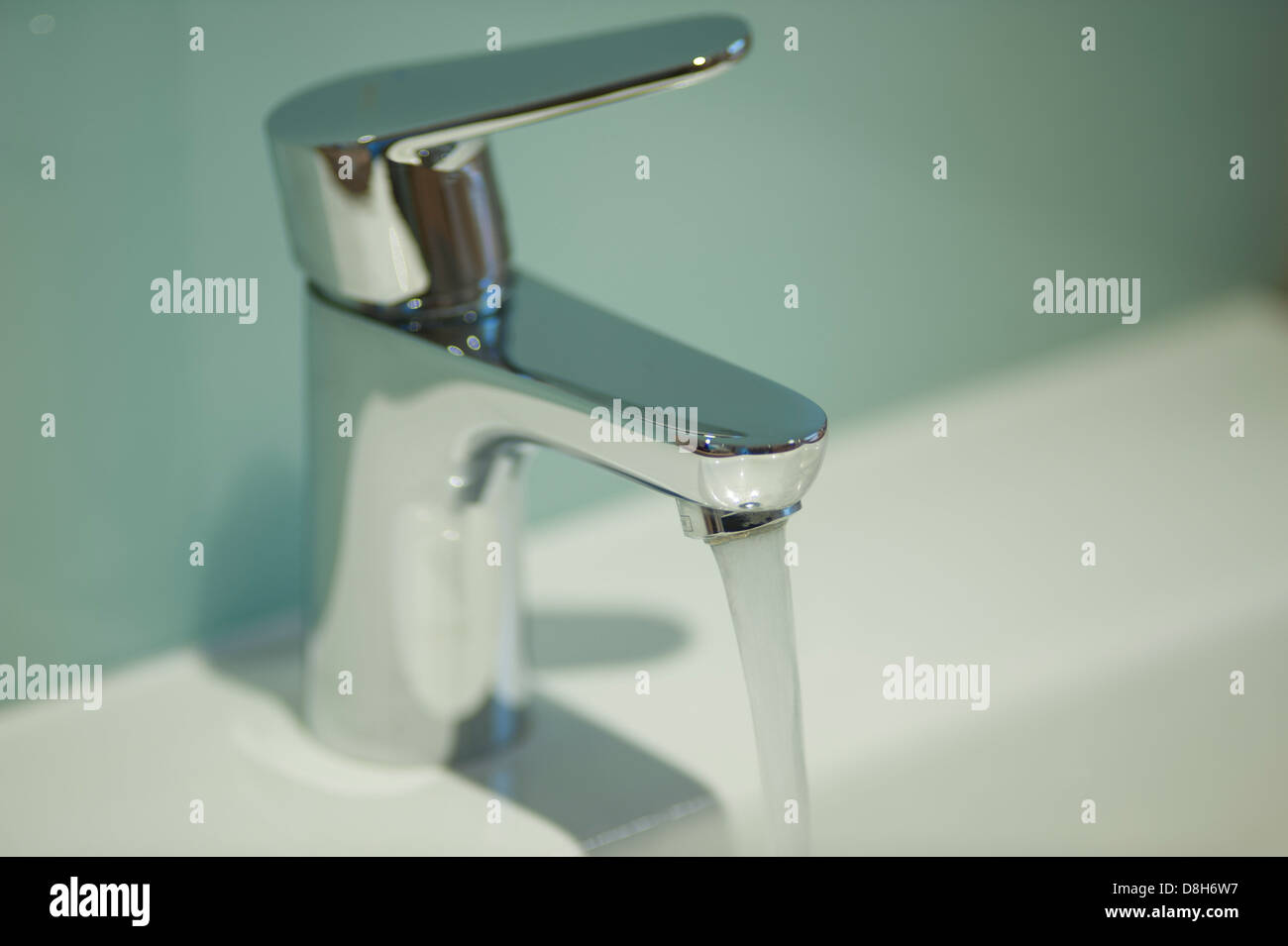 Water pouring from a contemporary tap Stock Photo - Alamy