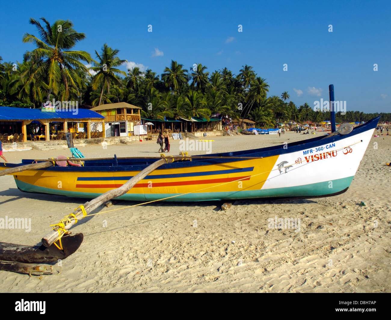 A traditional wooden outrigger fishing boat on Palolem beach, South Goa ...