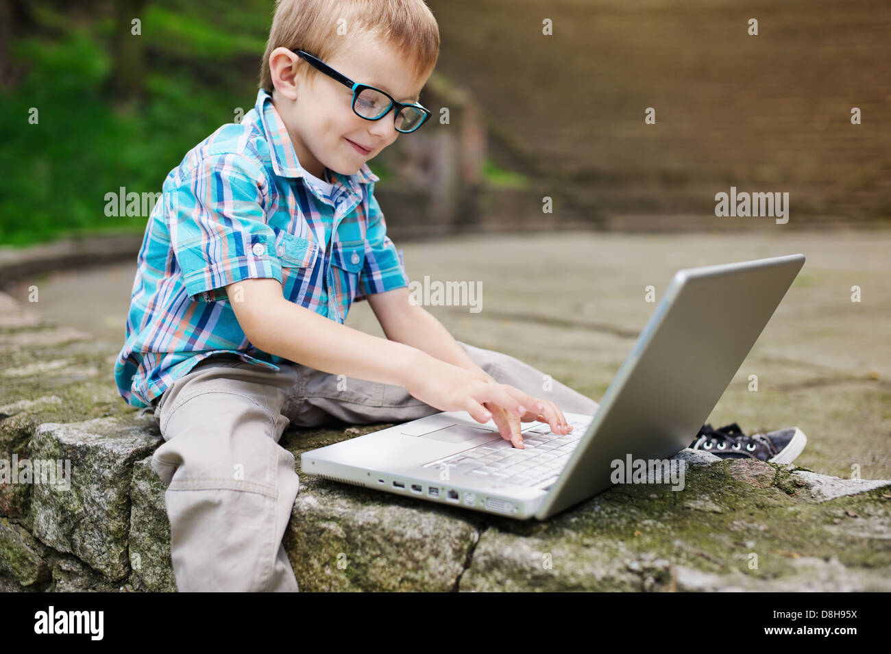 Happy boy with laptop Stock Photo - Alamy
