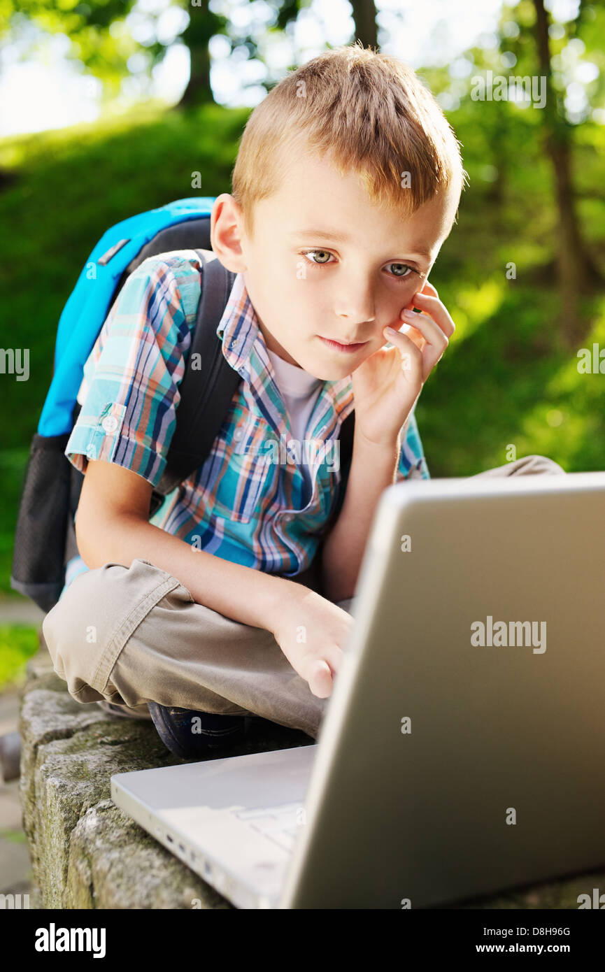 Boy with notebook in the park Stock Photo - Alamy