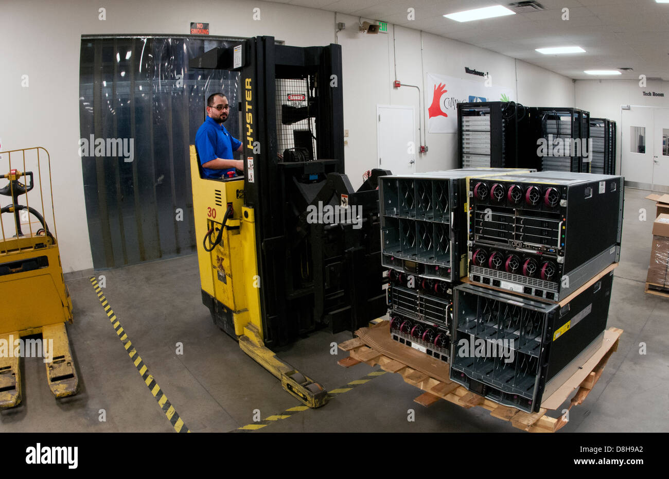computer technology IT company shipping inventory man with forklift ...