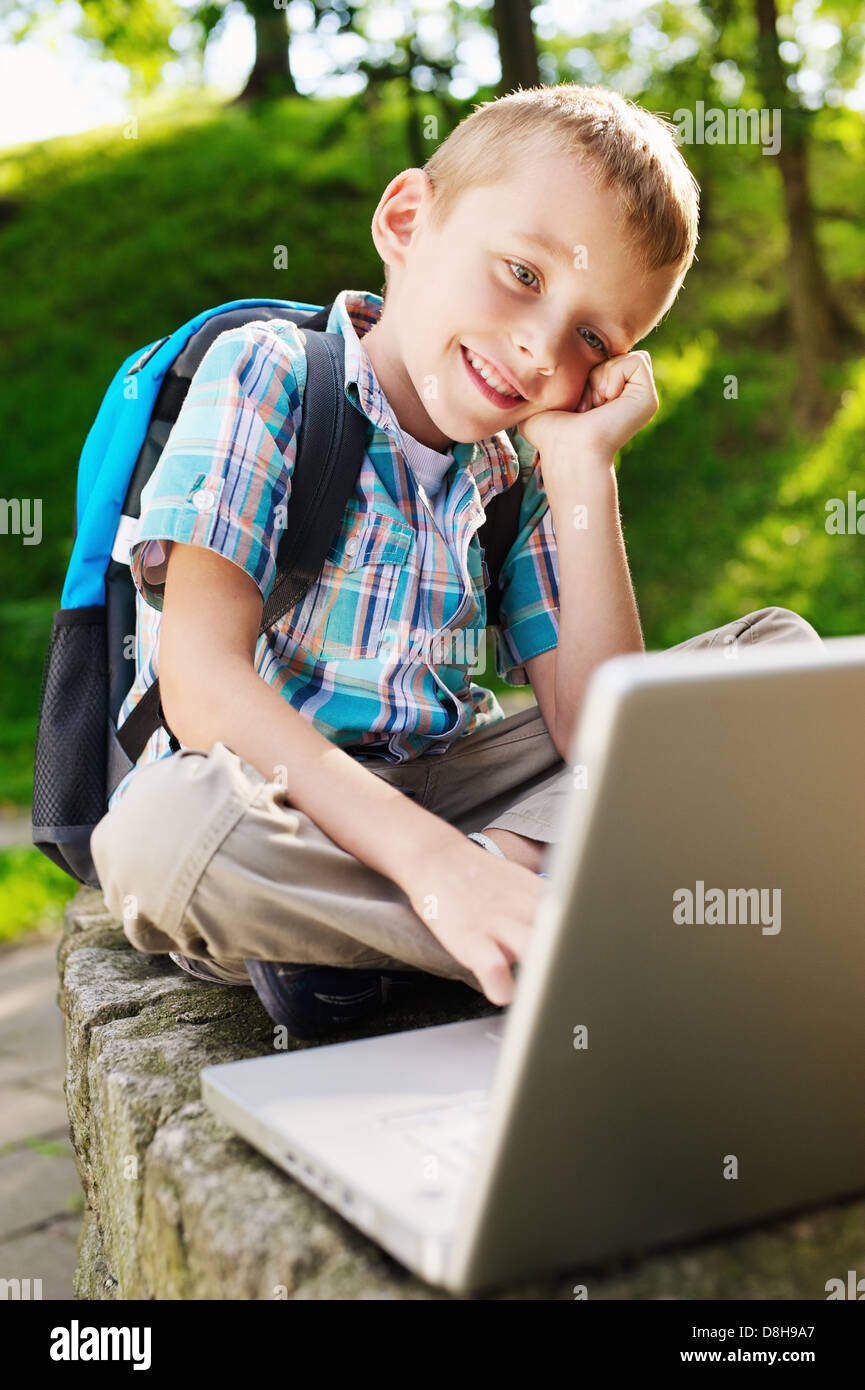 Lucky boy browsing internet on mobile computer Stock Photo - Alamy