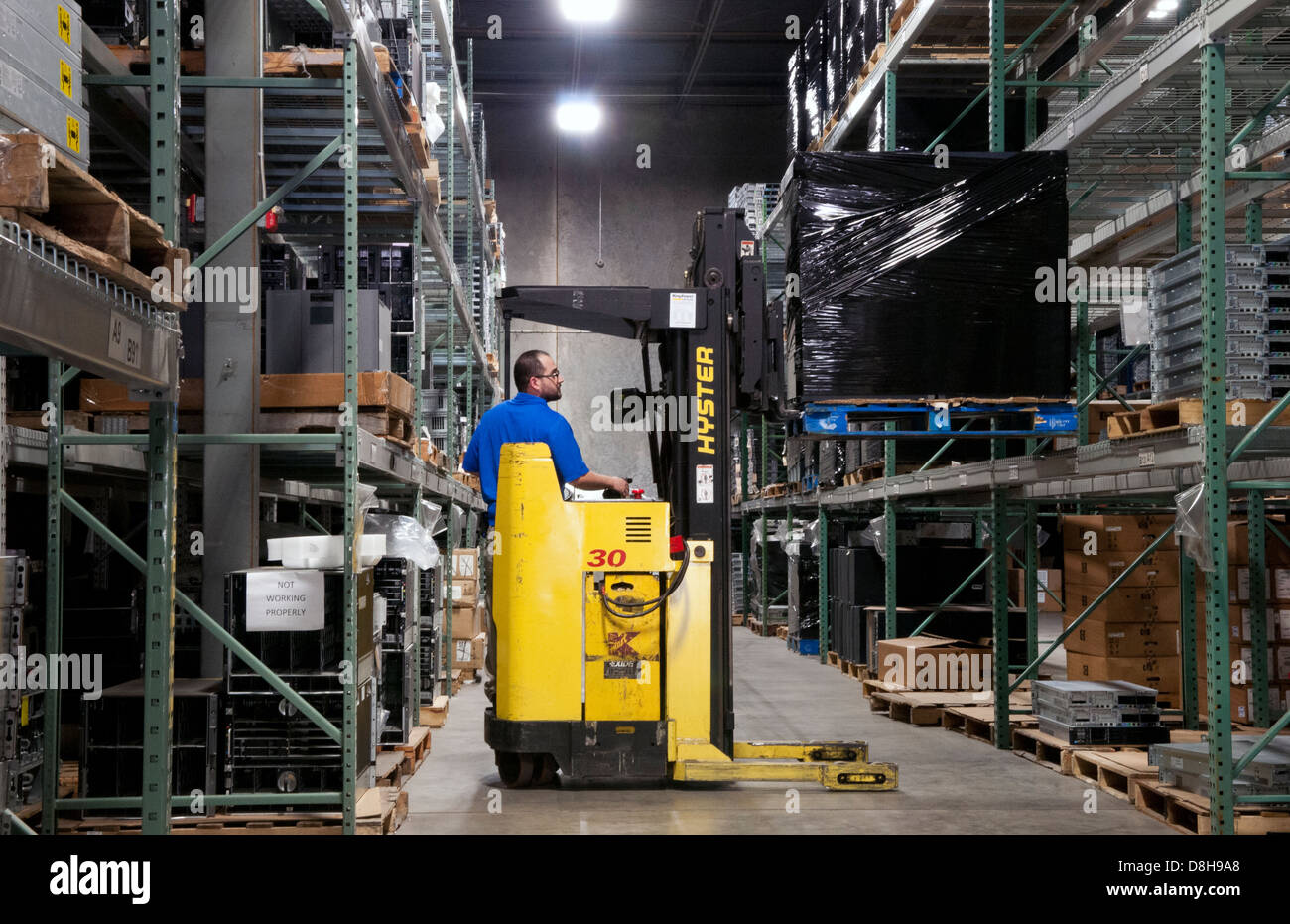 computer technology IT company shipping inventory man with forklift ...