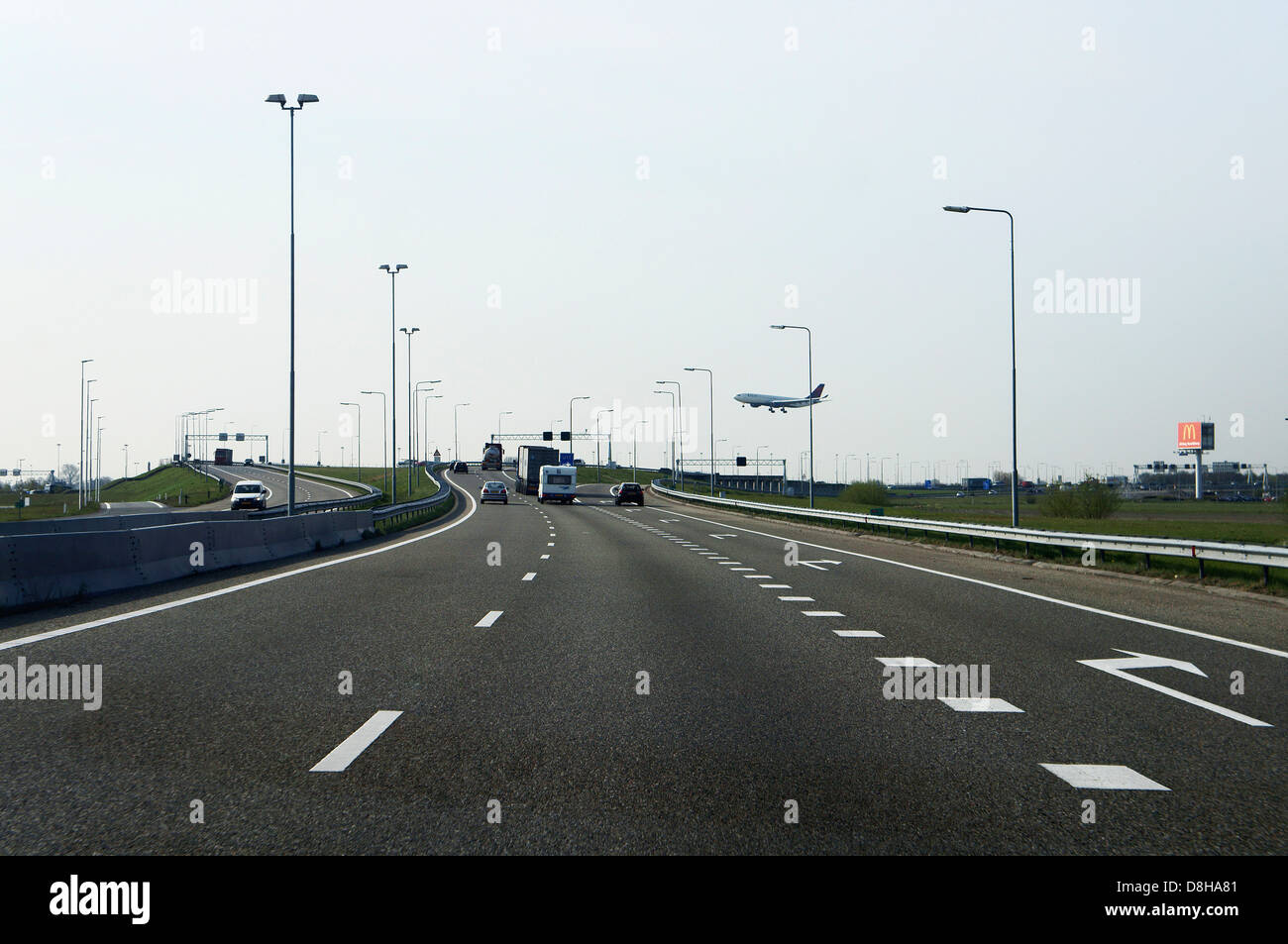 Delta airline plane cross A5 motorway at Amsterdam's Schiphol Airport ...