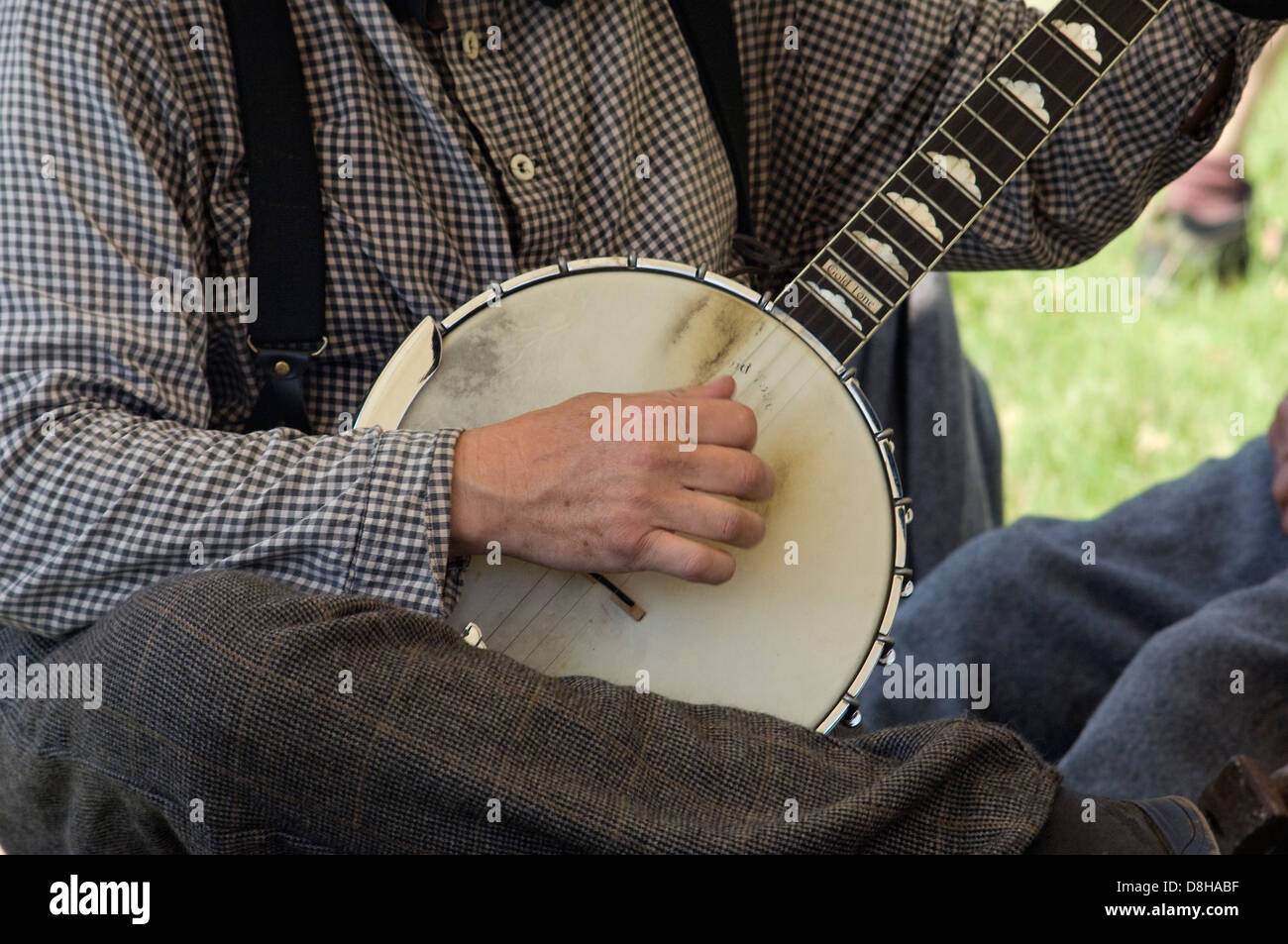 Confederate soldier reenactor playing a banjo in camp, Shiloh National ...