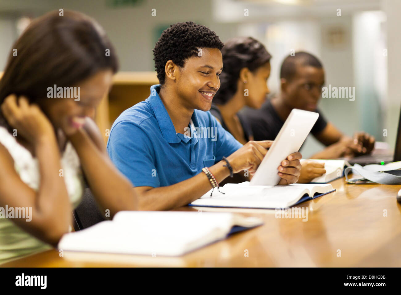 happy male african american college student using tablet computer Stock ...