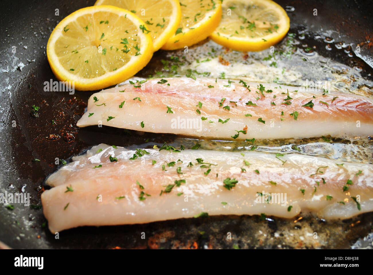 Cooking White Fish with Lemon Slices Stock Photo - Alamy