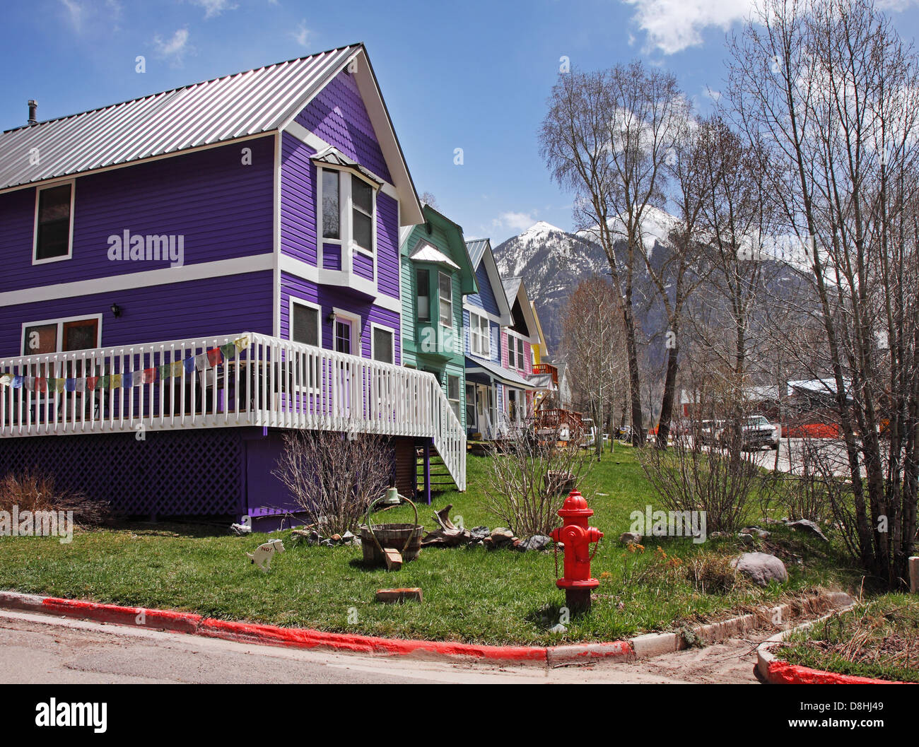 Row of colorful houses in Colorado, USA, with snow capped mountain in ...