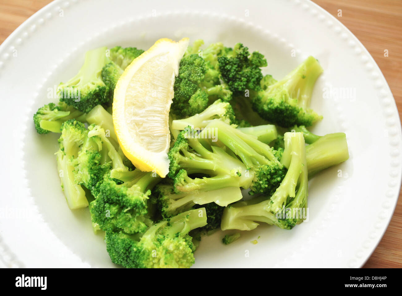 Chopped Broccoli with a Fresh Lemon Slice Stock Photo - Alamy