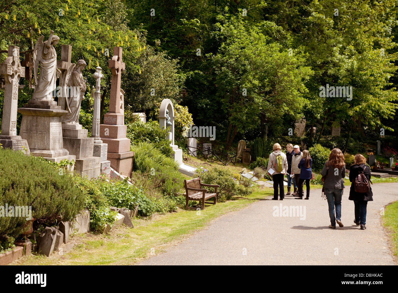 Visitors looking at the famous graves in Highgate cemetery East, London ...
