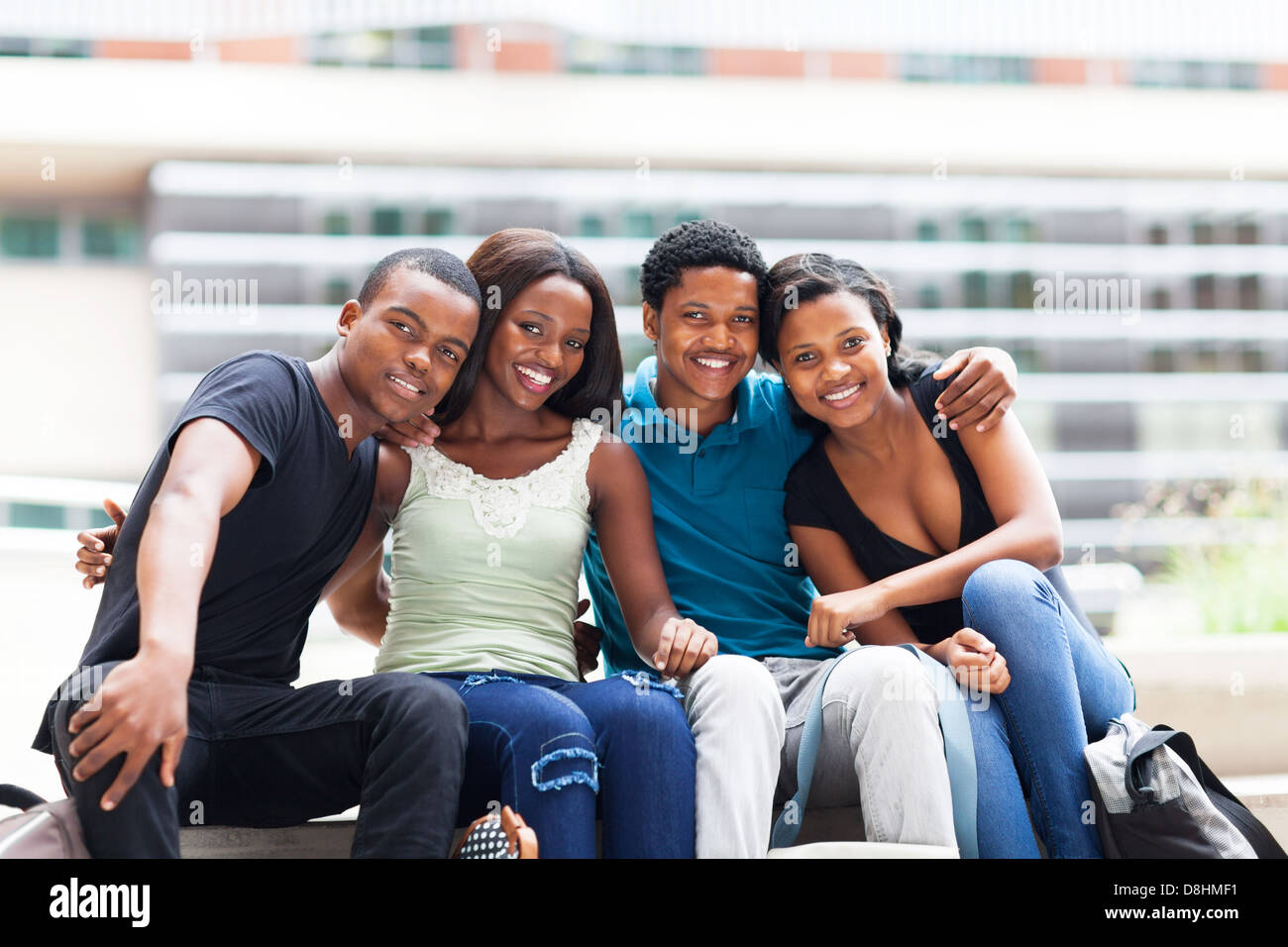 group of happy african college students sitting outdoors Stock Photo ...